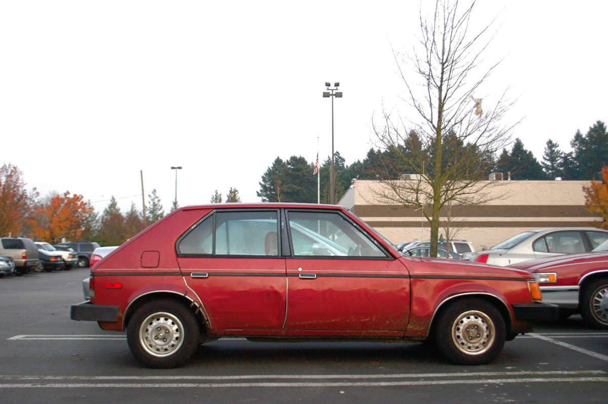 OLD PARKED CARS.: 1986 Dodge Omni.