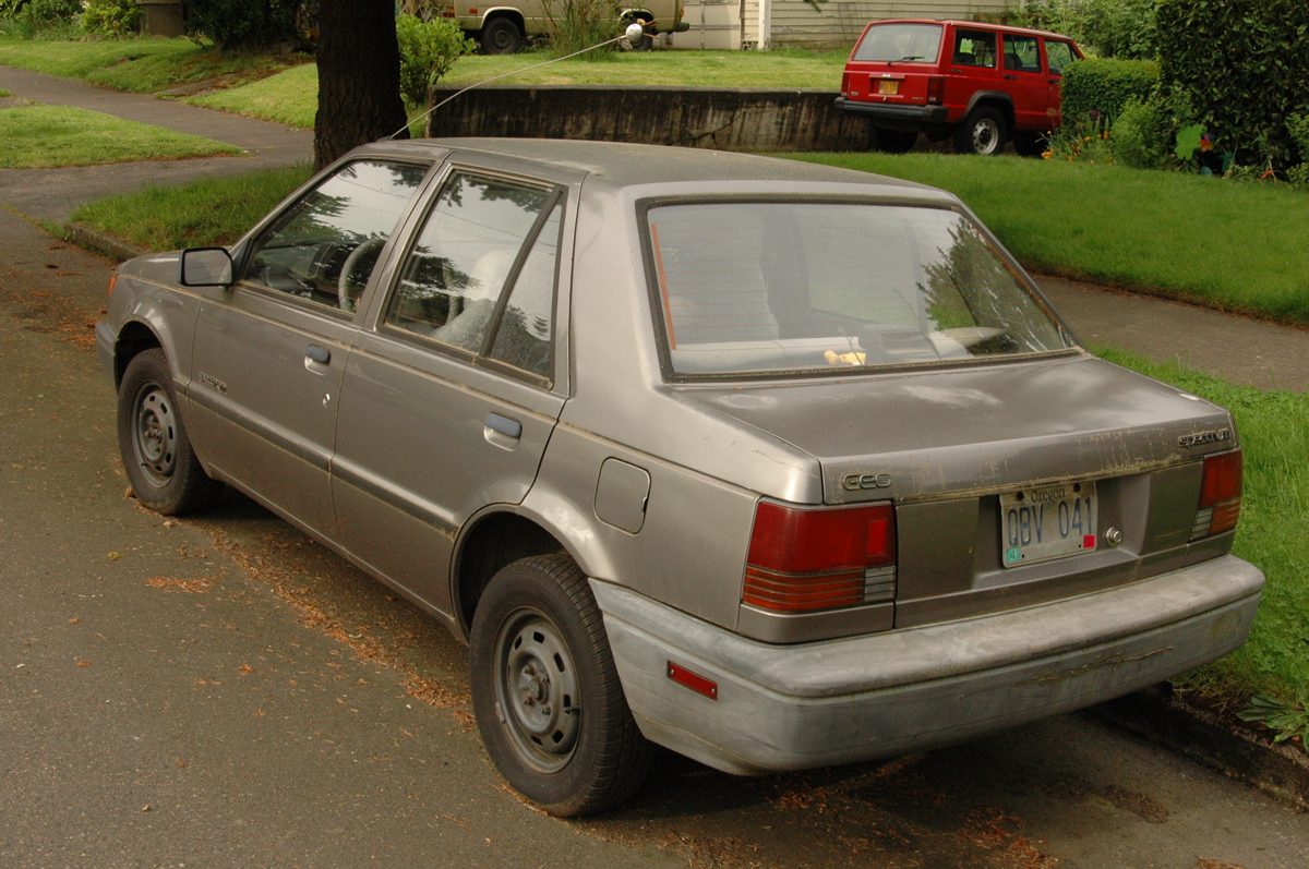 OLD PARKED CARS.: 1989 Geo Spectrum.