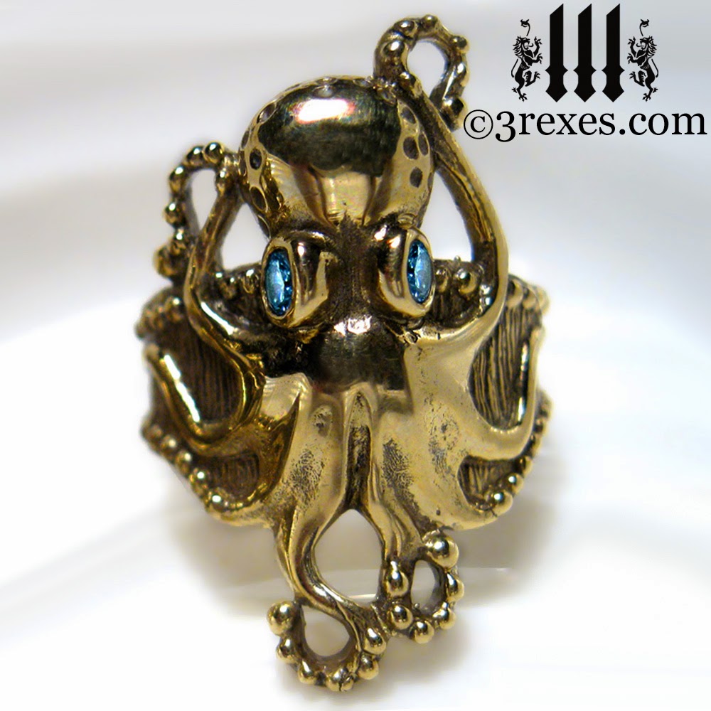 3 REXES JEWELRY: Octopus Dream Ring In Golden Brass n Blue Topaz