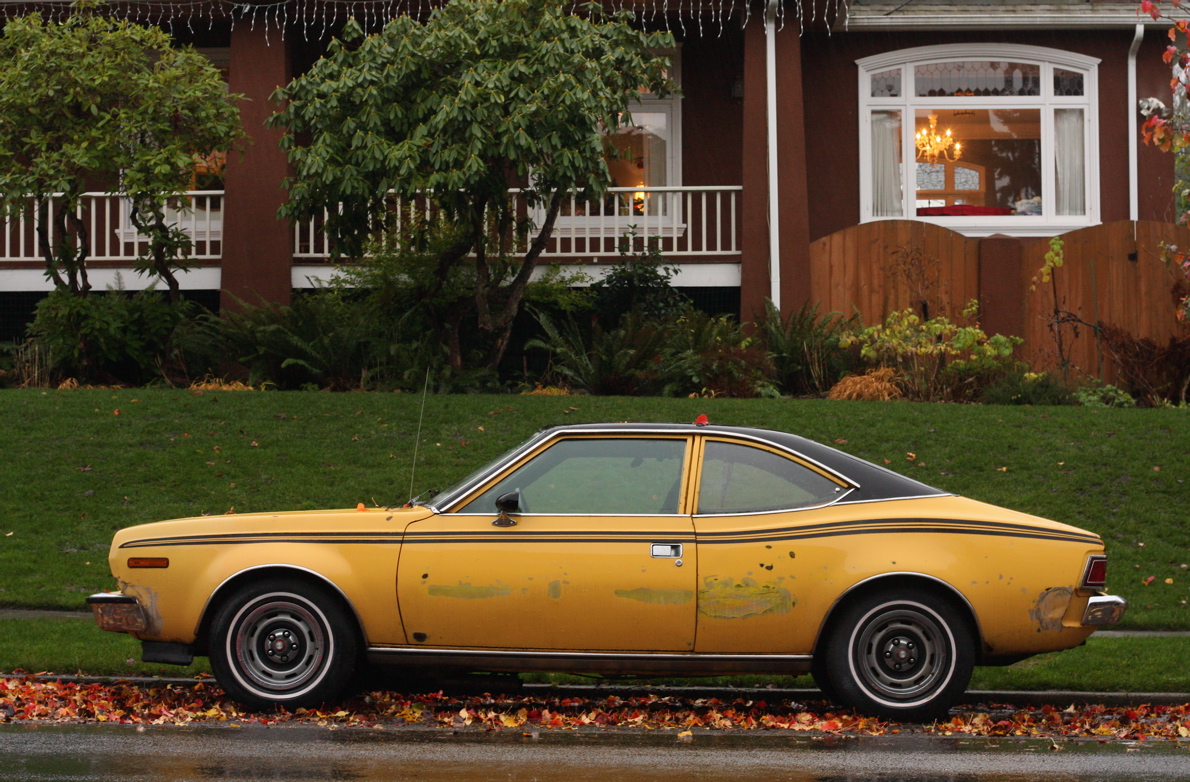 OLD PARKED CARS.: 1973 AMC Hornet X hatchback.