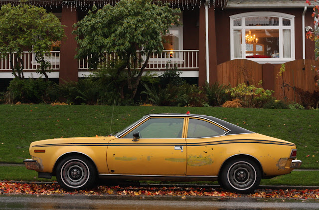 OLD PARKED CARS.: 1973 AMC Hornet X hatchback.