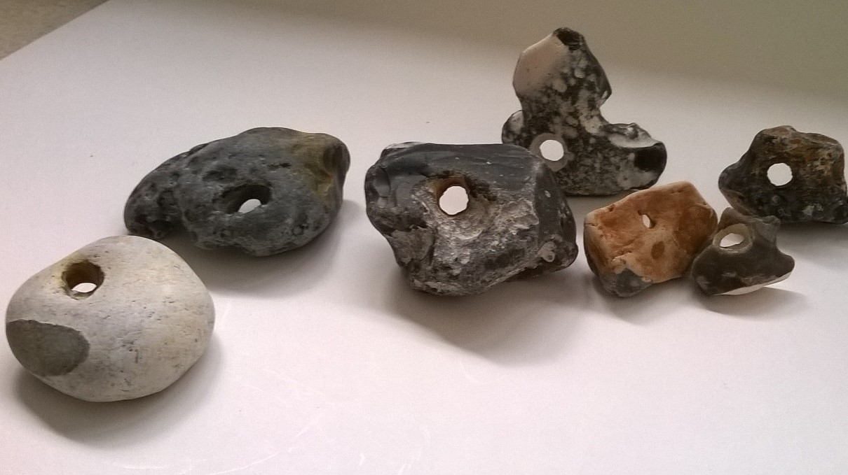 Inexplicable DeVice: Holes with stones around them...