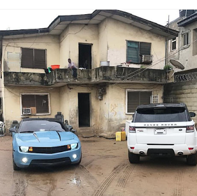 Check out this photo of 2 posh cars in an old looking house