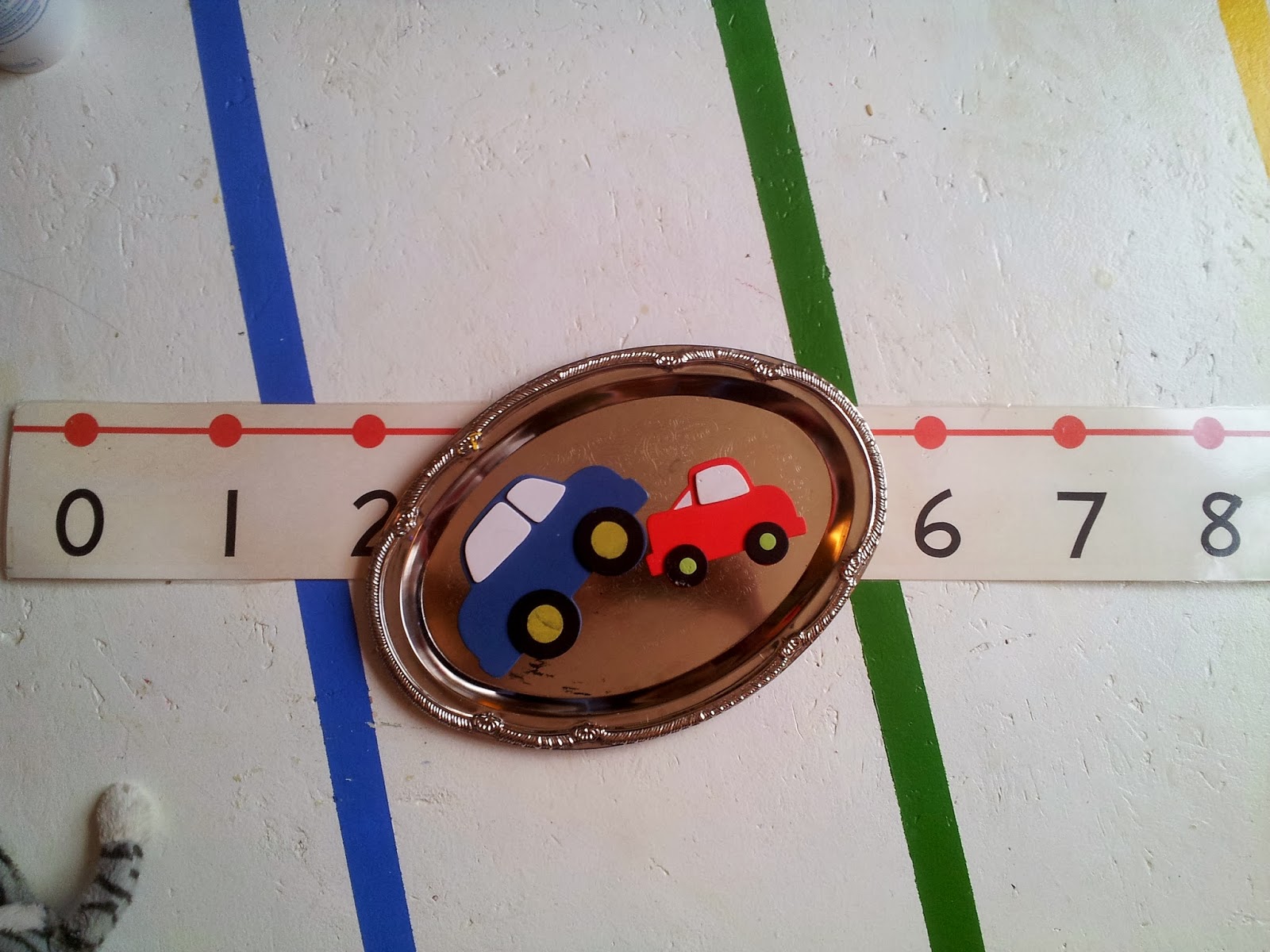 Driving wooden cars up and down a number line. We played several games ...