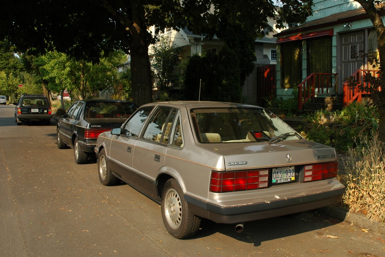 OLD PARKED CARS.: The American Dream: 2X 1986 Dodge Lancer ES Turbo.