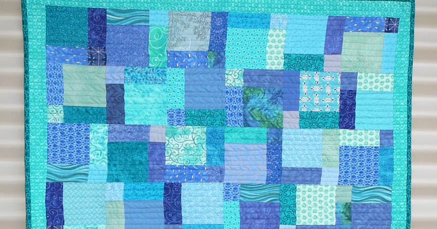 Patchy Work of Mini Grey: An Aqua Quilt.