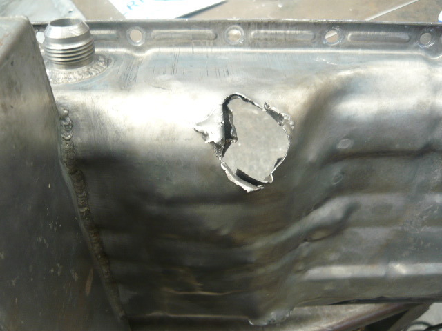 Engine destroyed with piston through block wall