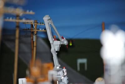 Mile Post 426: New traffic light in town/Lineman working on transformer