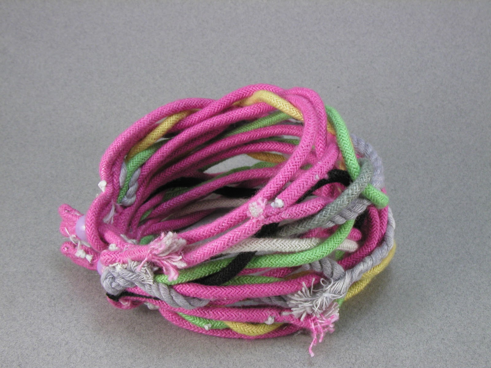 Knots and fiber bracelets: tangled string bracelet in green and pink 930