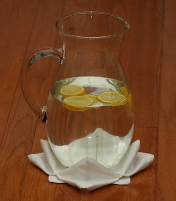 DigiCrumbs: How To Fold A Napkin Rose to set under a Beverage Pitcher