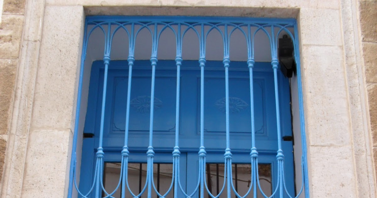 brightly coloured sunflowers: Wrought iron railings - fer forgé