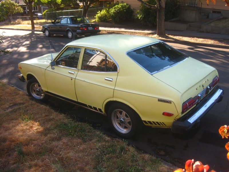 OLD PARKED CARS.: 1975 Datsun 710 4-Door Fastback.