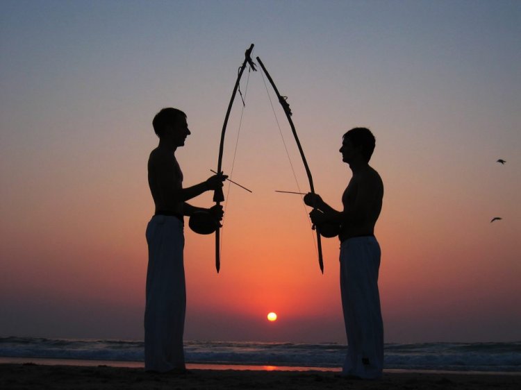 Berimbau, the soul of Capoeira, leads the acrobatic dance movements of ...