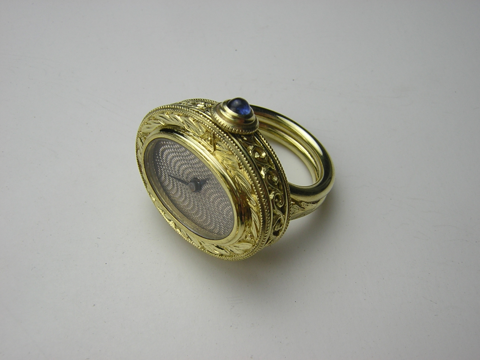 HANDMADE WATCHES: A LADIES 18K GOLD RING WATCH