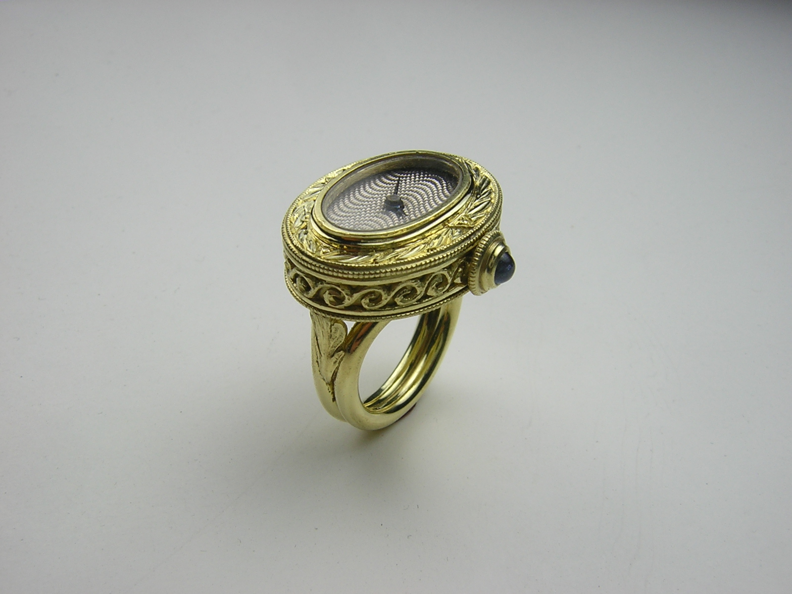HANDMADE WATCHES: A LADIES 18K GOLD RING WATCH