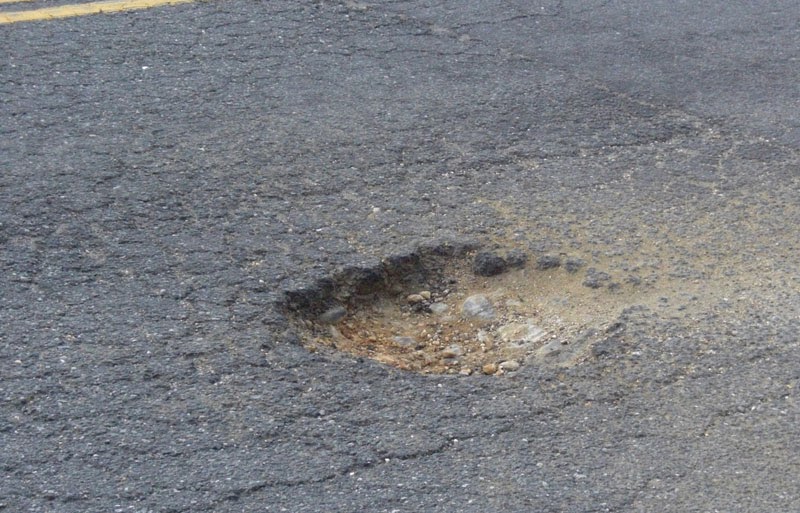 Ode Street Tribune: deep pothole on 14th St.