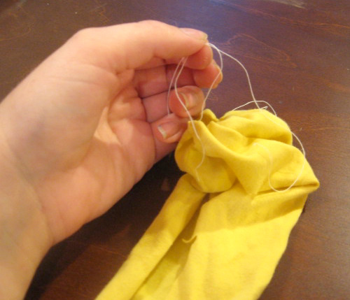 When both ends are gathered and tied off, tuck them together and sew ...